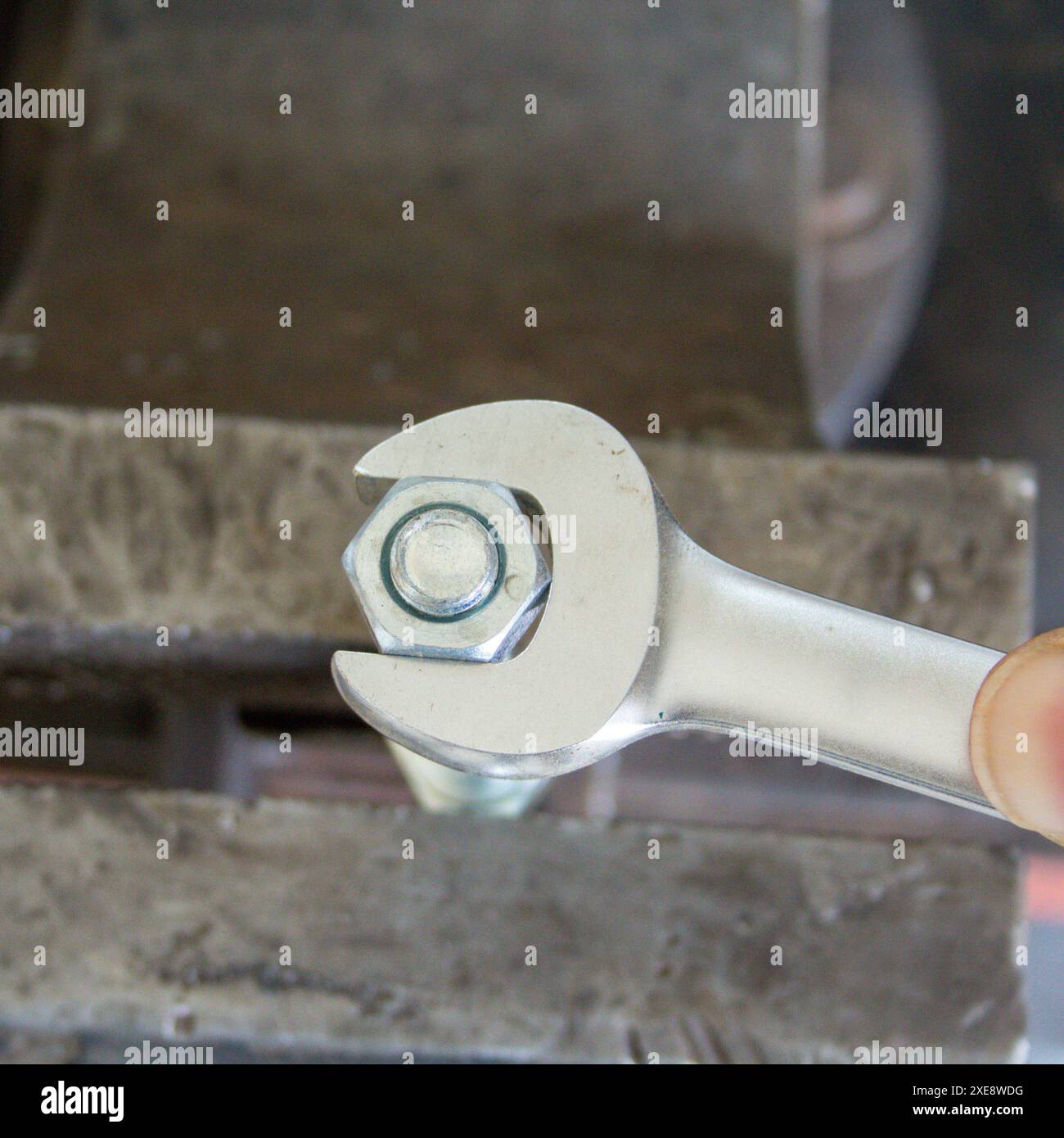Image of a mechanic's hand tightening a bolt with a wrench. DIY work in ...