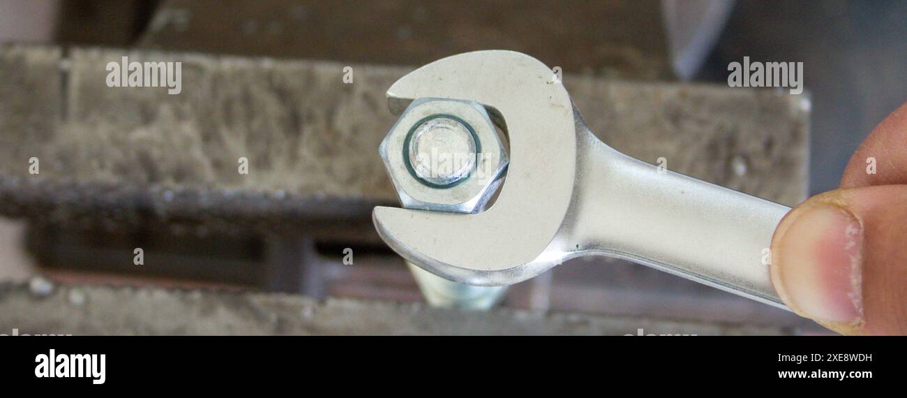 Image of a mechanic's hand tightening a bolt with a wrench. DIY work in ...