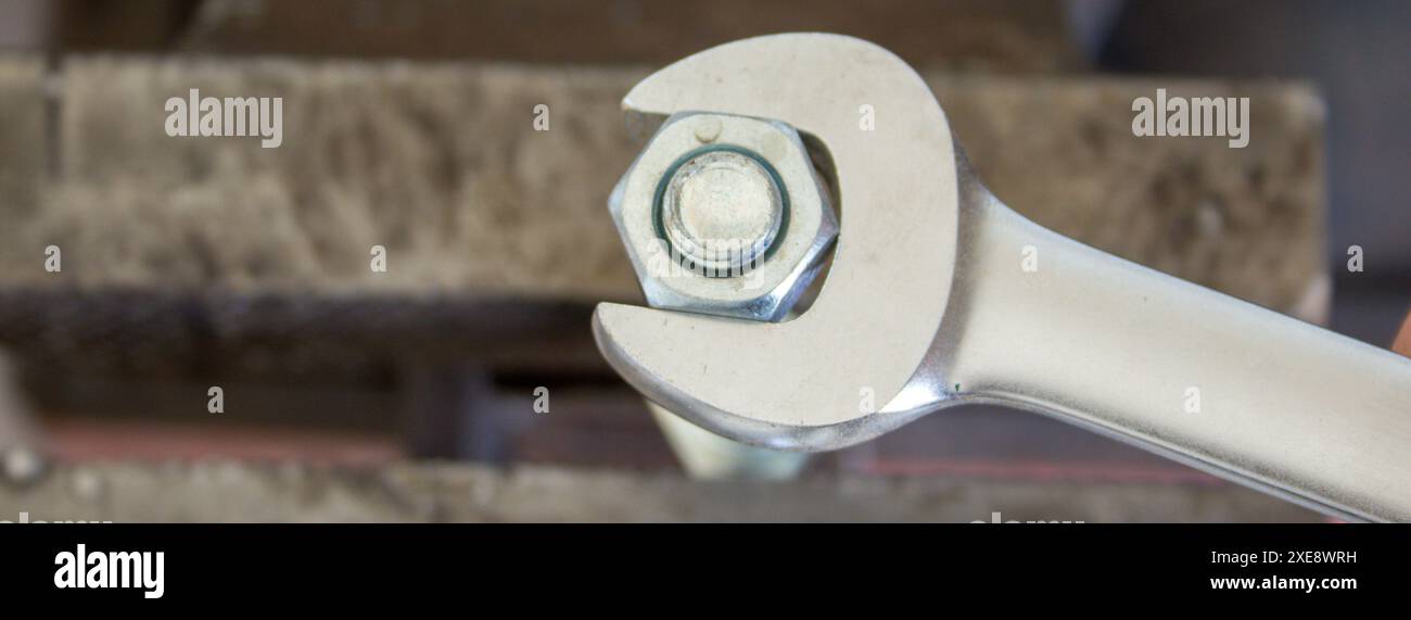 Image of a mechanic's hand tightening a bolt with a wrench. DIY work in ...