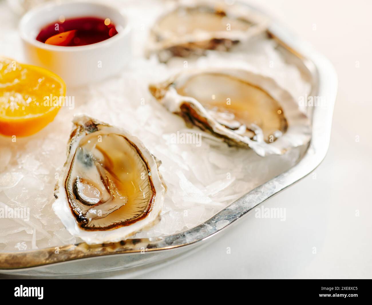Girl eating oysters hi-res stock photography and images - Alamy