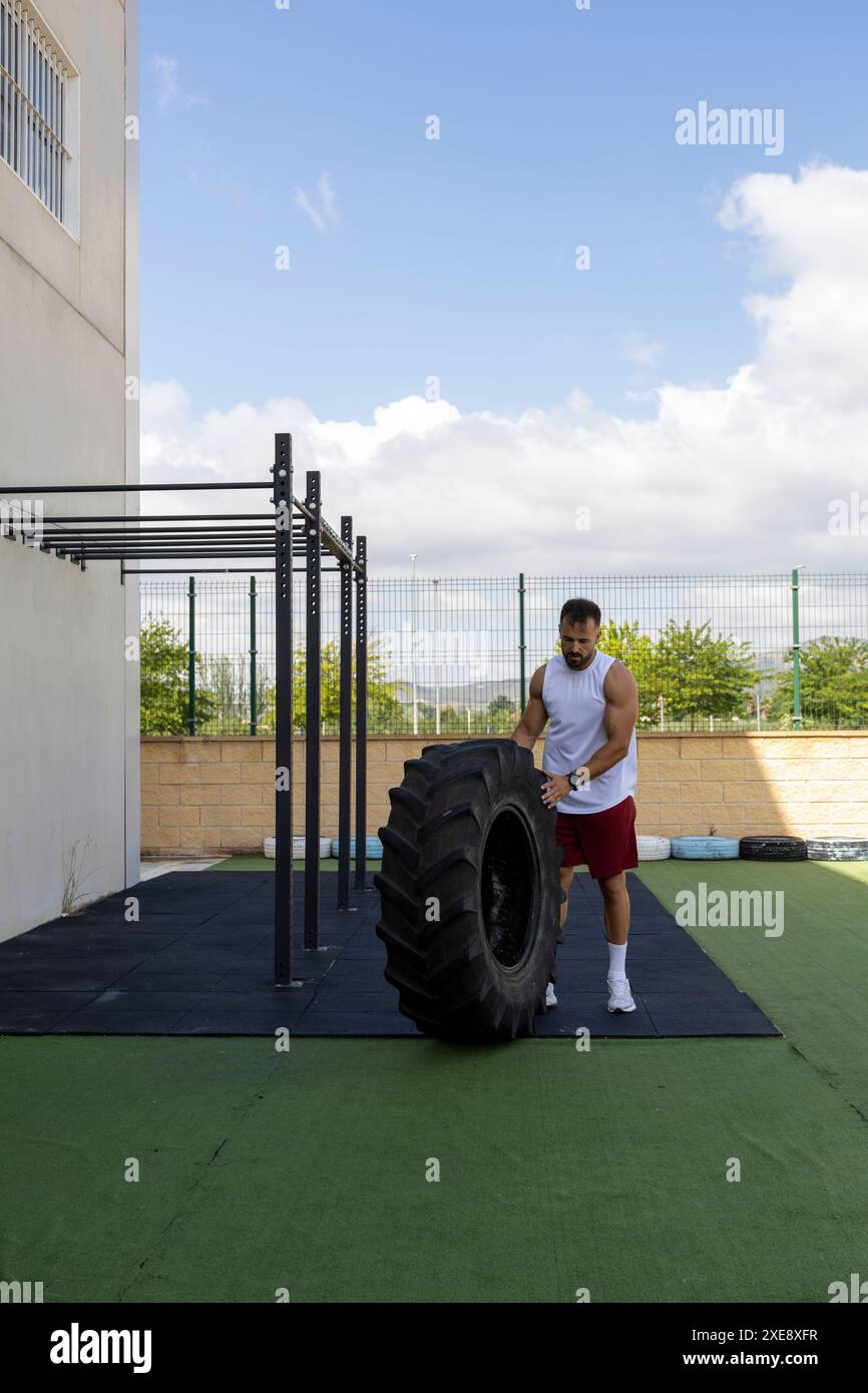 Strong man training crossfit with truck wheel Stock Photo - Alamy