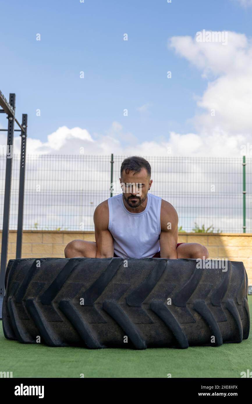 Strong man training crossfit with truck wheel Stock Photo - Alamy