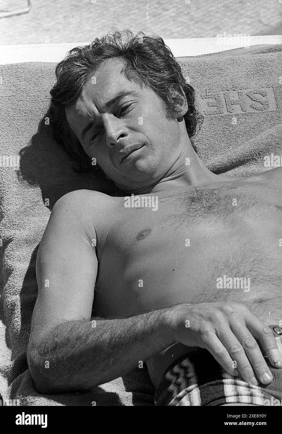 French car racer Jean-Pierre Beltoise takes a sun bath during the Gran ...