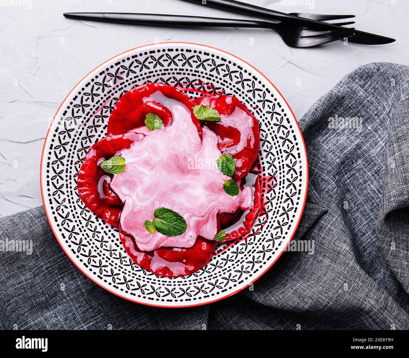 Vegan red ravioli with beetroot on a plate in cream sauce Stock Photo ...