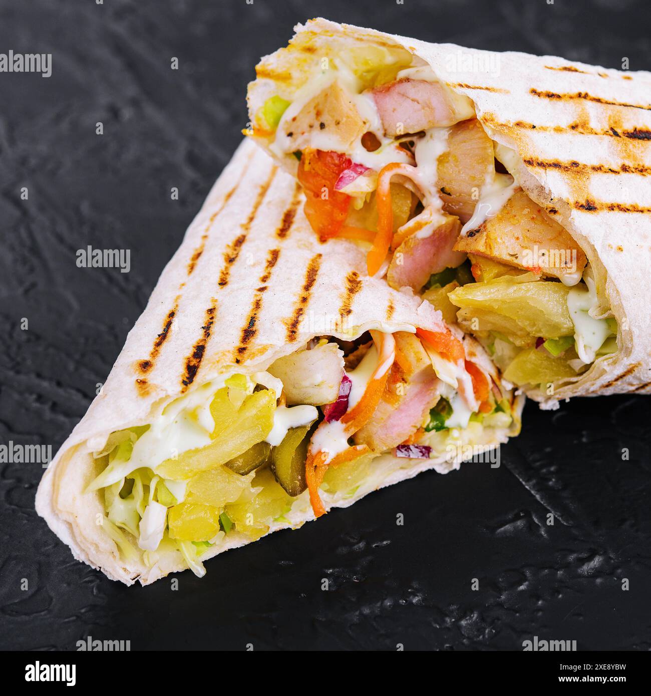Delicious chicken shawarma on black stone Stock Photo - Alamy