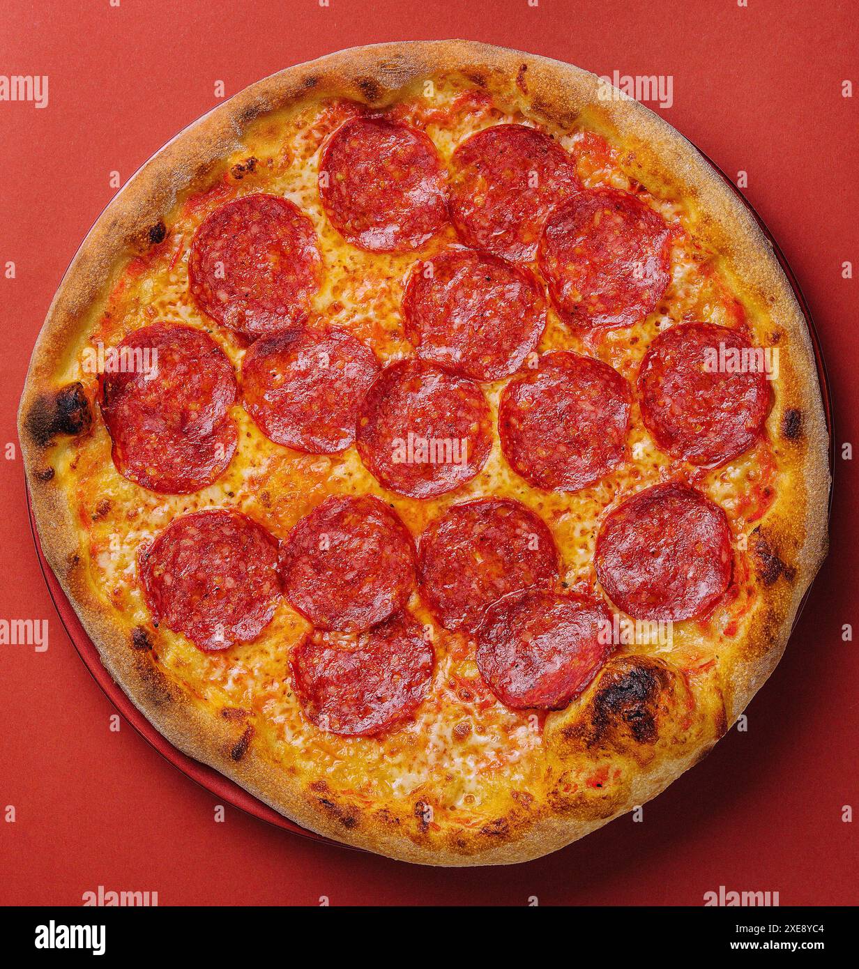 Fresh tasty pizza with pepperoni on red background Stock Photo - Alamy