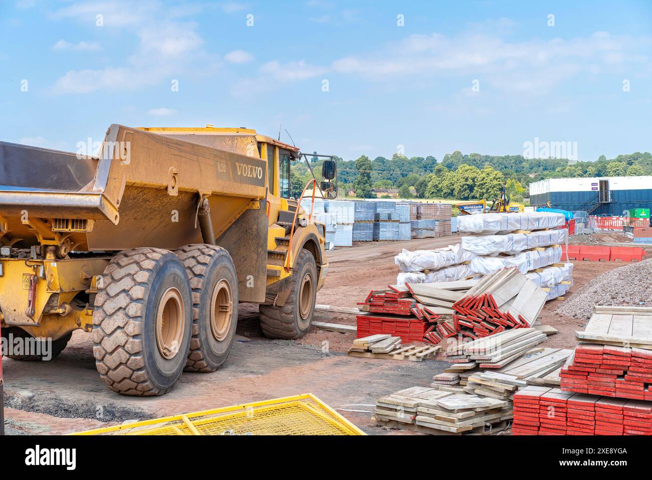 Rear view of a large, yellow Volvo dumper truck being used on a UK ...