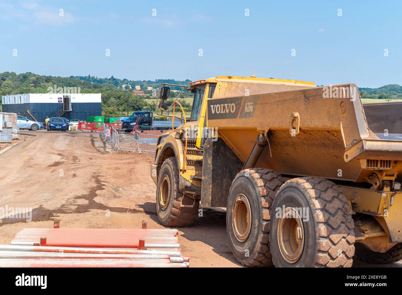 Construction site vehicles on a new build building site. Rear view of a ...