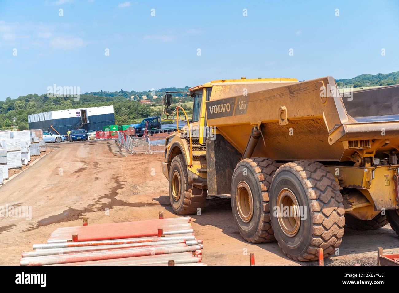 Construction site vehicles on a new build building site. Rear view of a ...