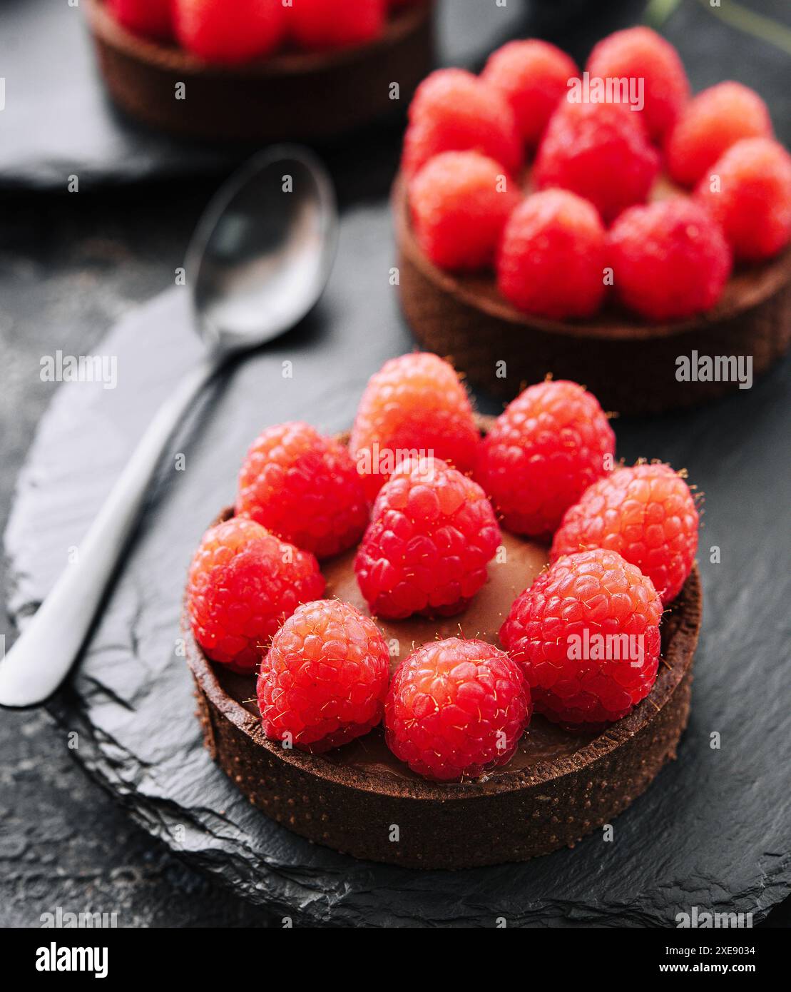 Chocolate cakes with raspberry close up Stock Photo - Alamy