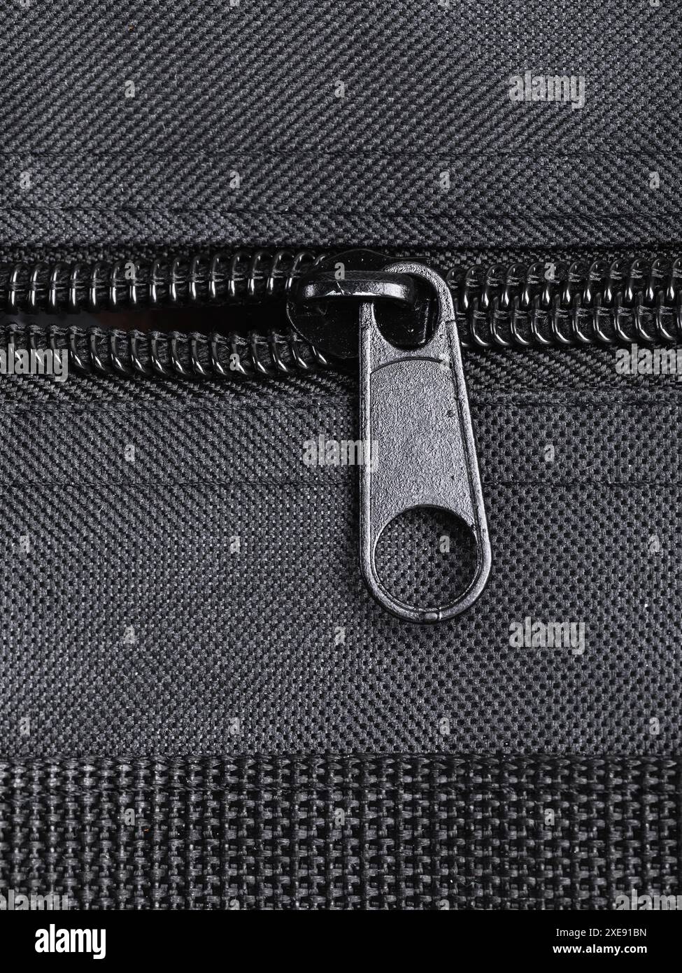 Half open zipper with a lock on the textile surface of a bag ...