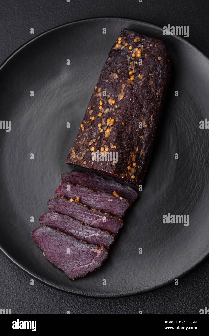 Delicious smoked Armenian basturma with spices and herbs Stock Photo ...