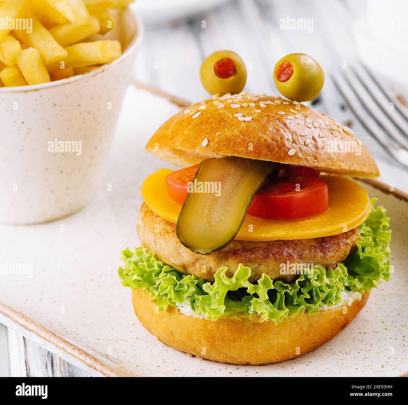 Mini burger shows tongue. The concept of a favorite children's burger ...
