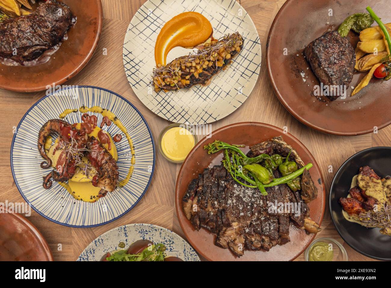 Top view image of various plates of different cuts of grilled beef ...
