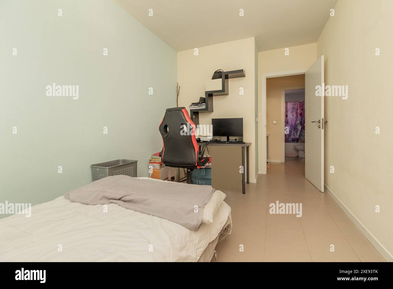 Bedroom with single bed with no decorations on the walls and a small ...