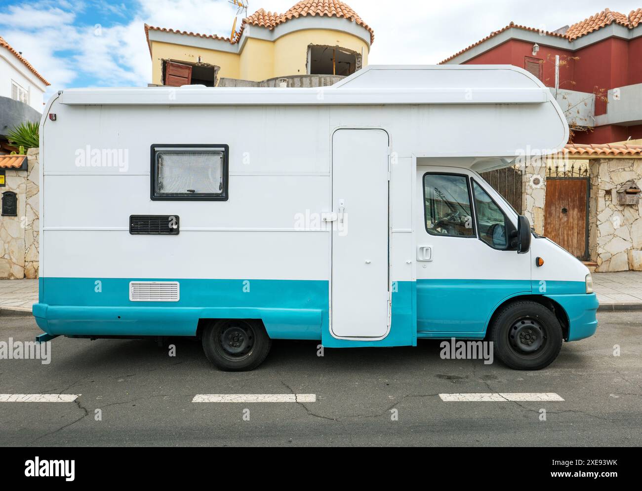 Small caravan parked in front of villa Stock Photo - Alamy