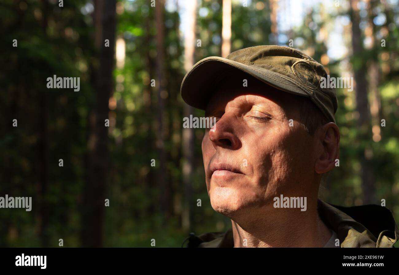 Mature man enjoying nature, breathing, inhaling fresh air in summer ...