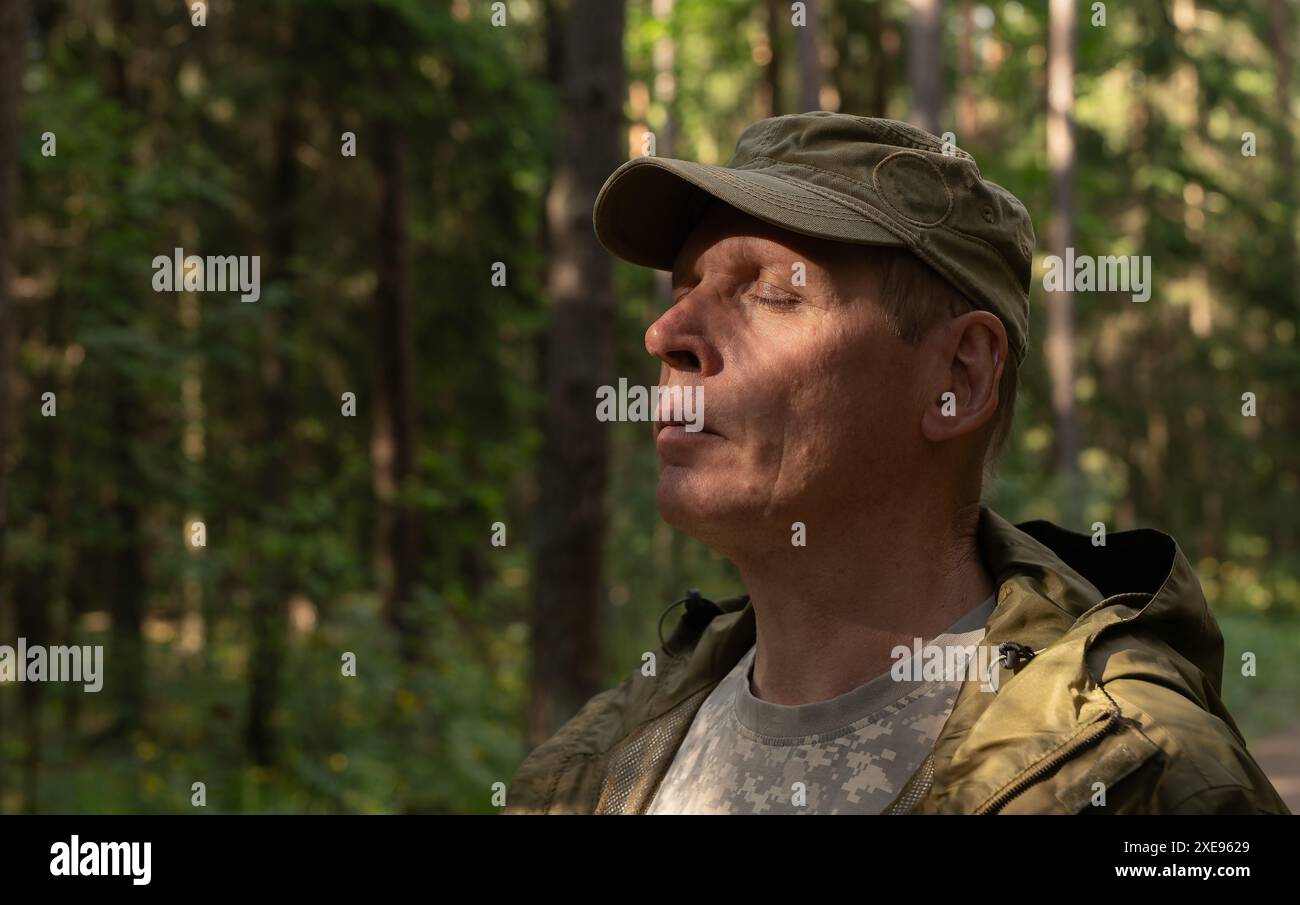 . Man enjoying nature, walking in woods, breathing, inhaling fresh air ...
