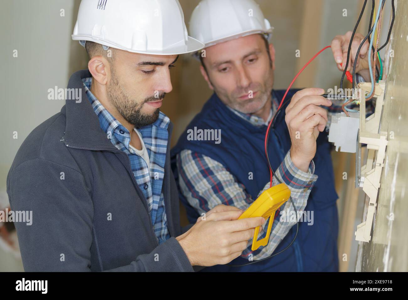 electrician measuring voltage of socket in new building Stock Photo - Alamy