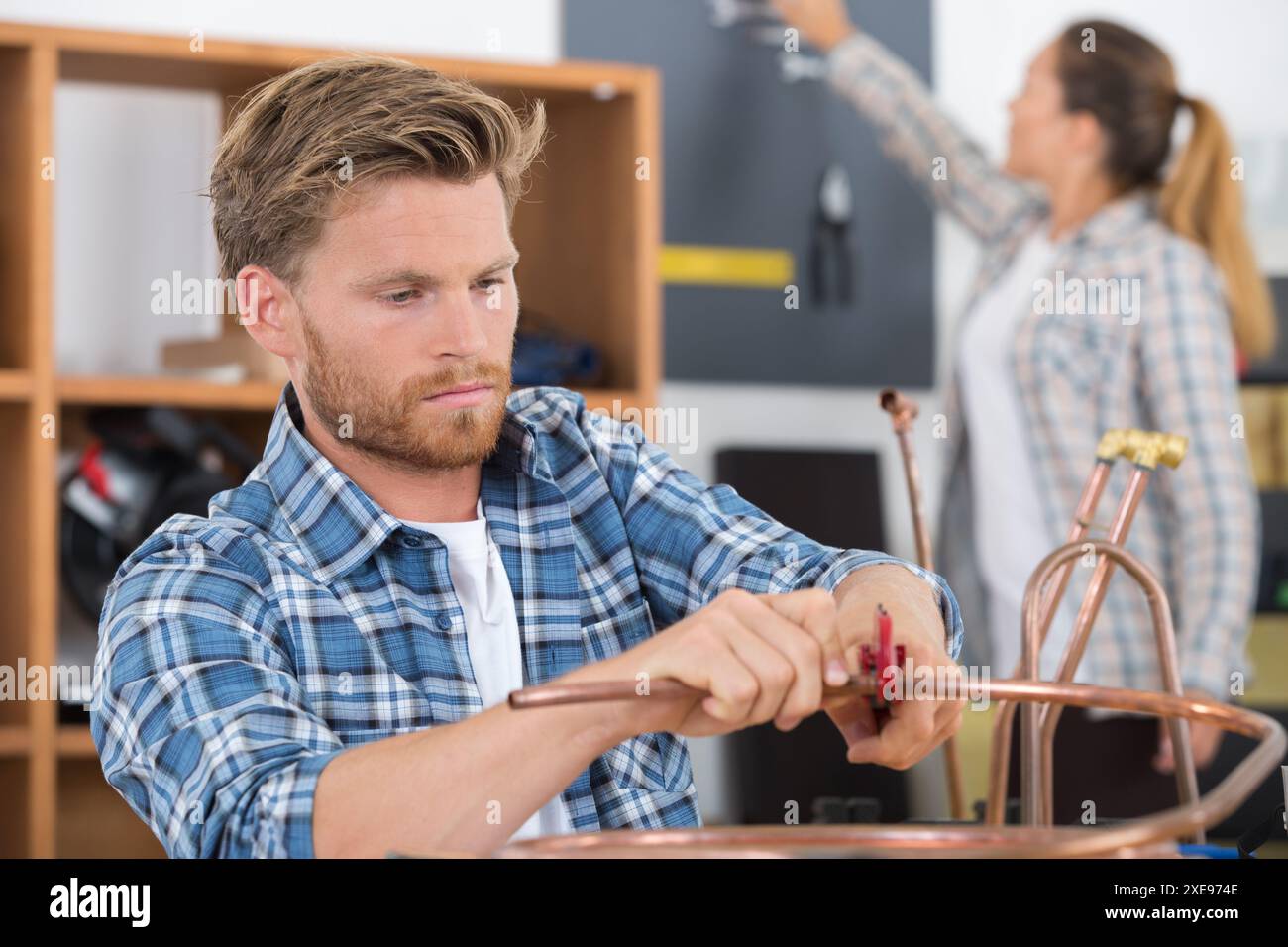 young plumber soldering pipe Stock Photo - Alamy