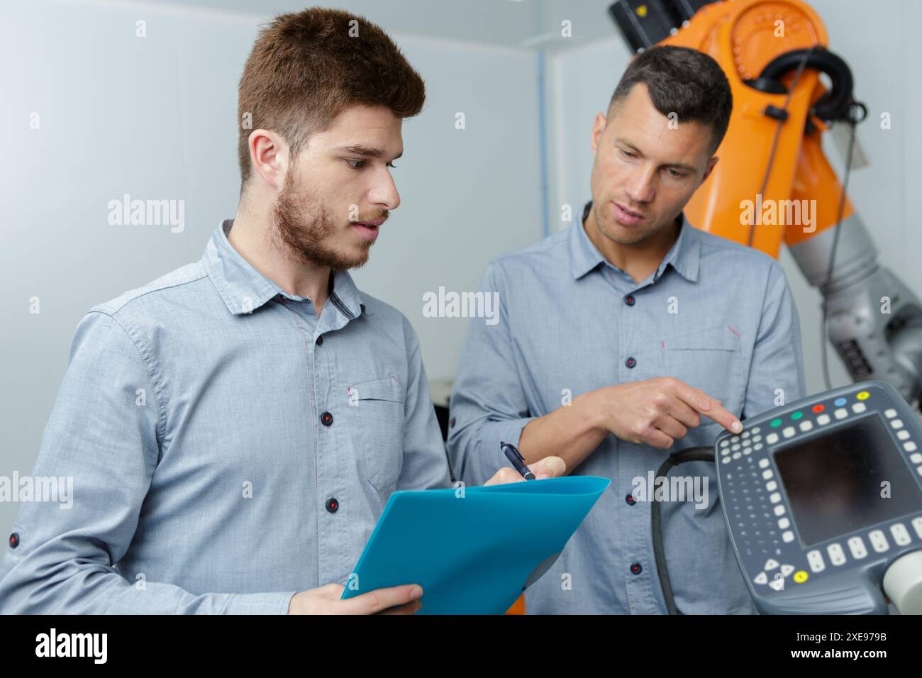 two students of technology working using a robotic arm Stock Photo - Alamy