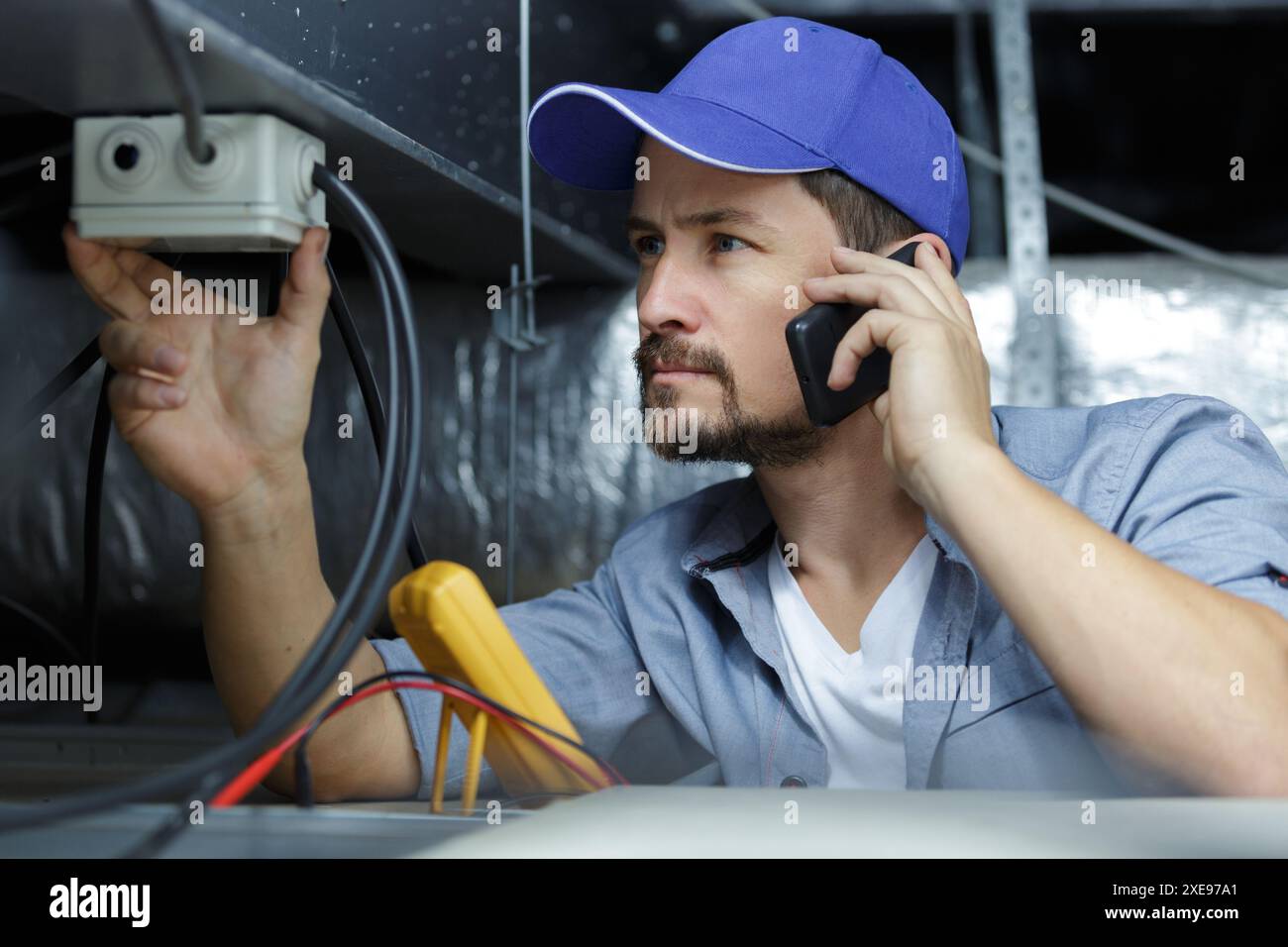 professional electrician making phone call while working Stock Photo ...