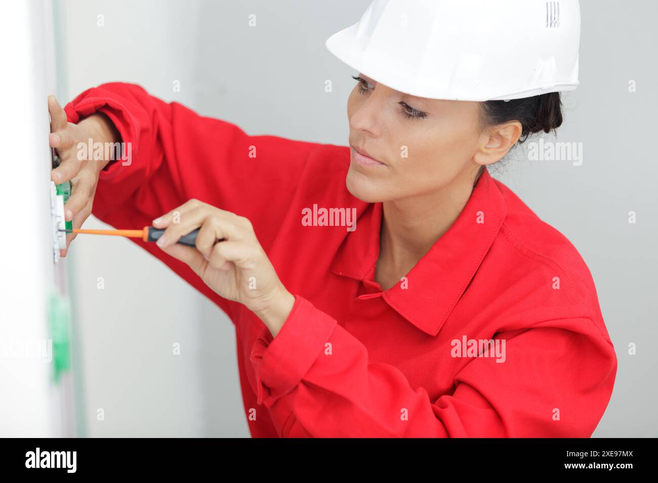 Female electrician fixing socket hi-res stock photography and images ...
