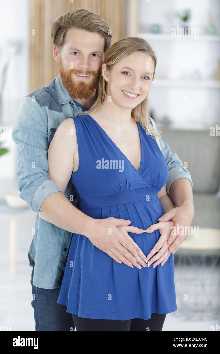 pregnant couple hugging and smiling Stock Photo - Alamy