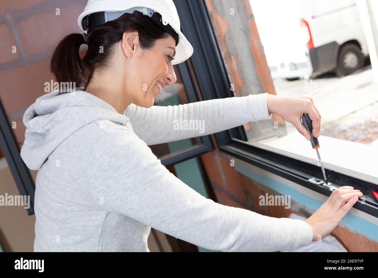 woman installing window with screwdriver Stock Photo - Alamy