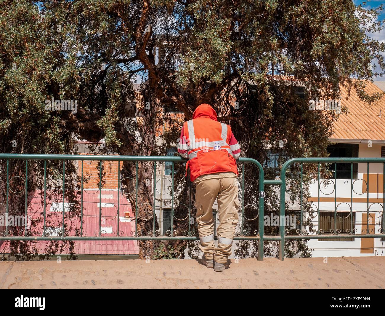 Worker Dressed in an Orange Vest and Security Clothing is Resting on a ...