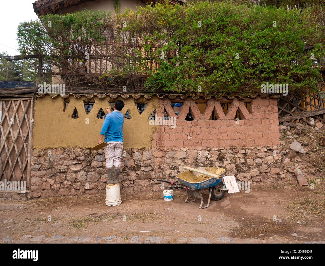 Man Wearing black Boots is Standing Over a Bucket of Paint and is ...