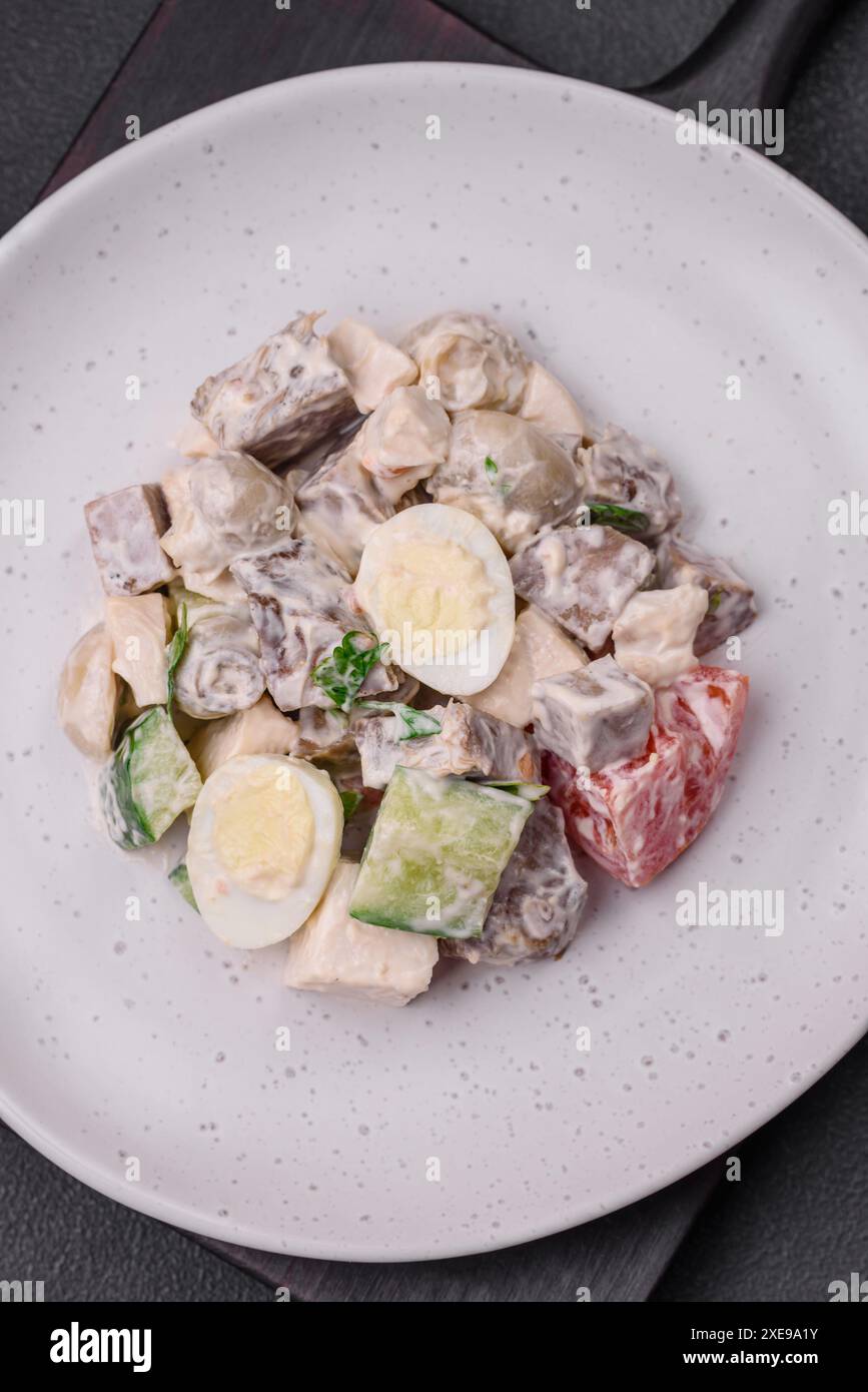 Delicious salad with boiled beef tongue, quail eggs, tomatoes and ...