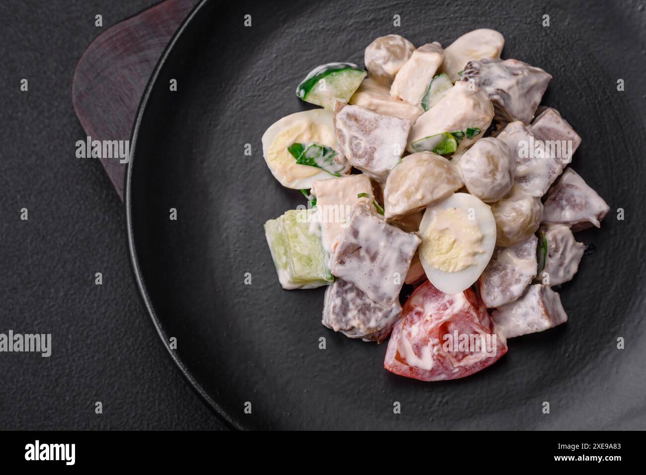 Delicious salad with boiled beef tongue, quail eggs, tomatoes and ...
