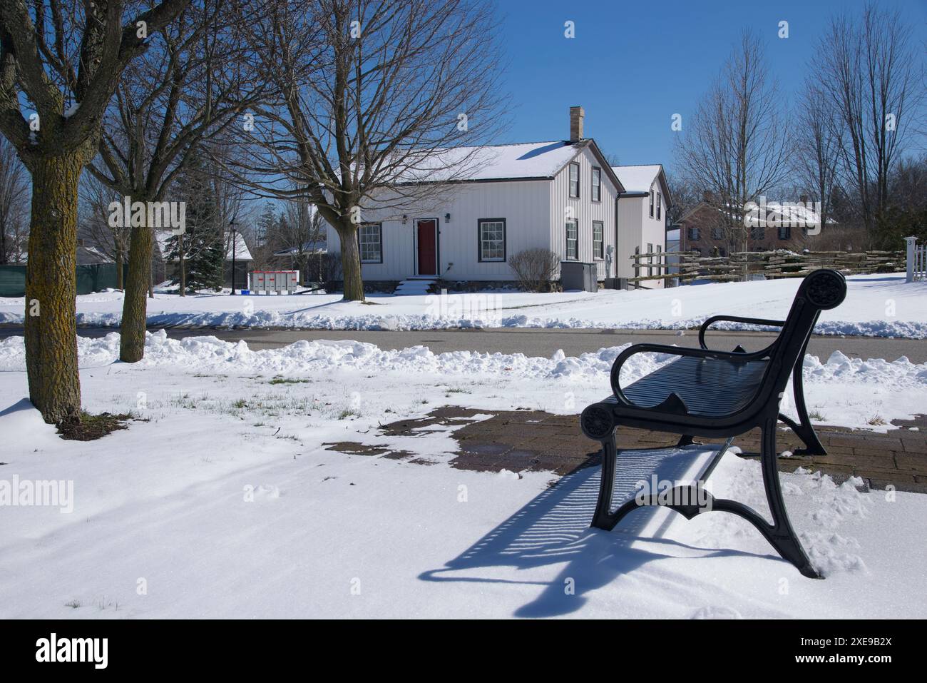 Empty park bench in the park of a small Canadian residential community ...