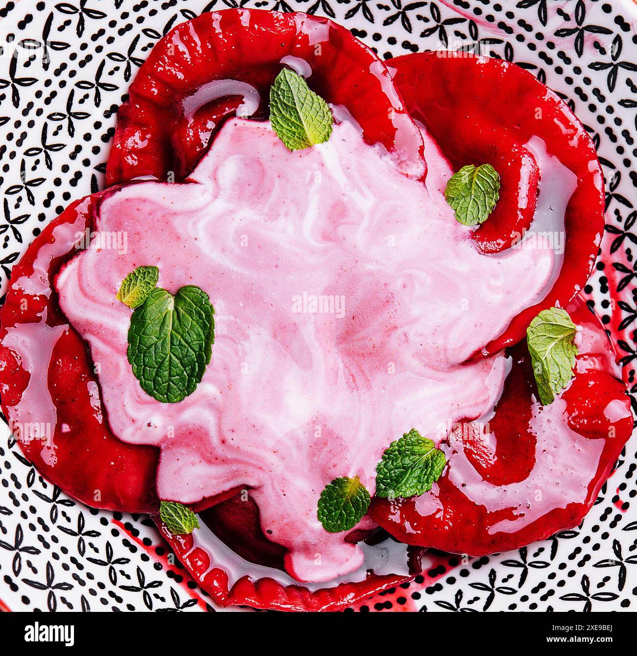 Vegan red ravioli with beetroot on a plate in cream sauce Stock Photo ...