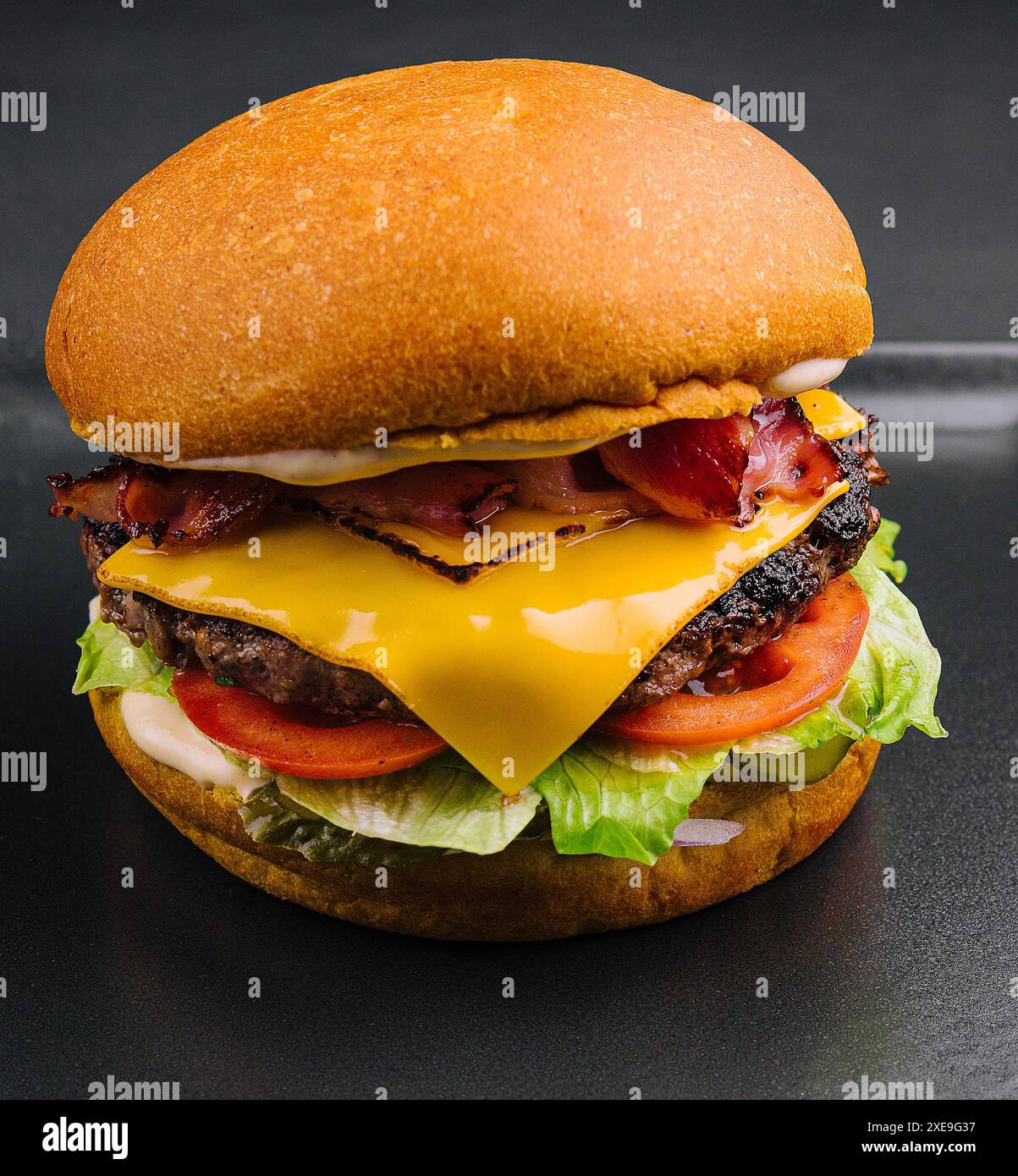 Bacon burger with beef patty on black tray Stock Photo - Alamy