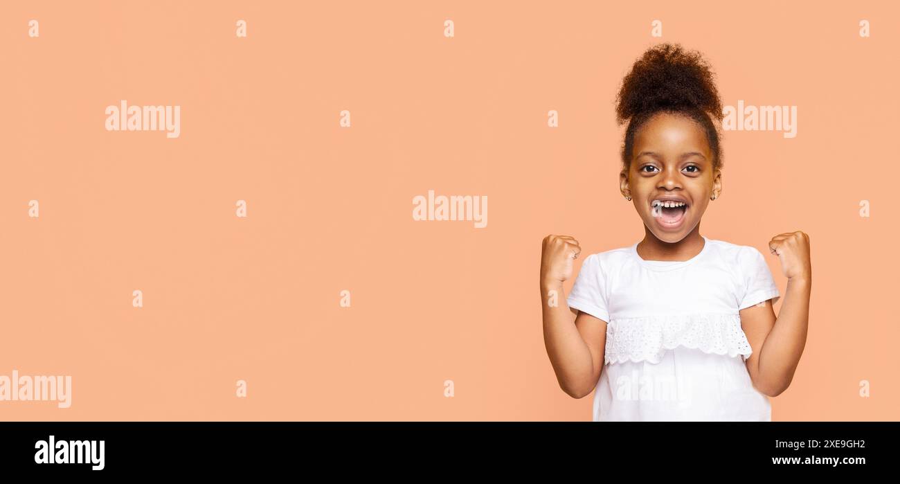Happy Little Girl Celebrating Success With a Big Smile Stock Photo - Alamy