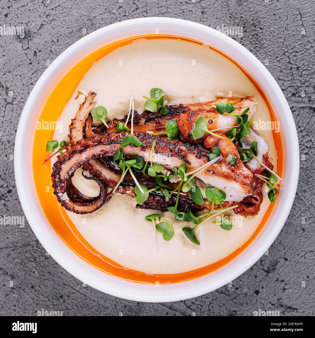 Grilled octopus with potato cream soup Stock Photo - Alamy