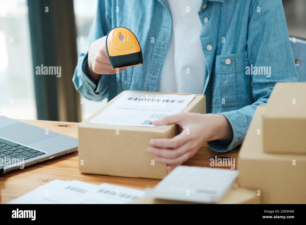 Scanning Barcode on Shipping Box with Scanner Stock Photo - Alamy