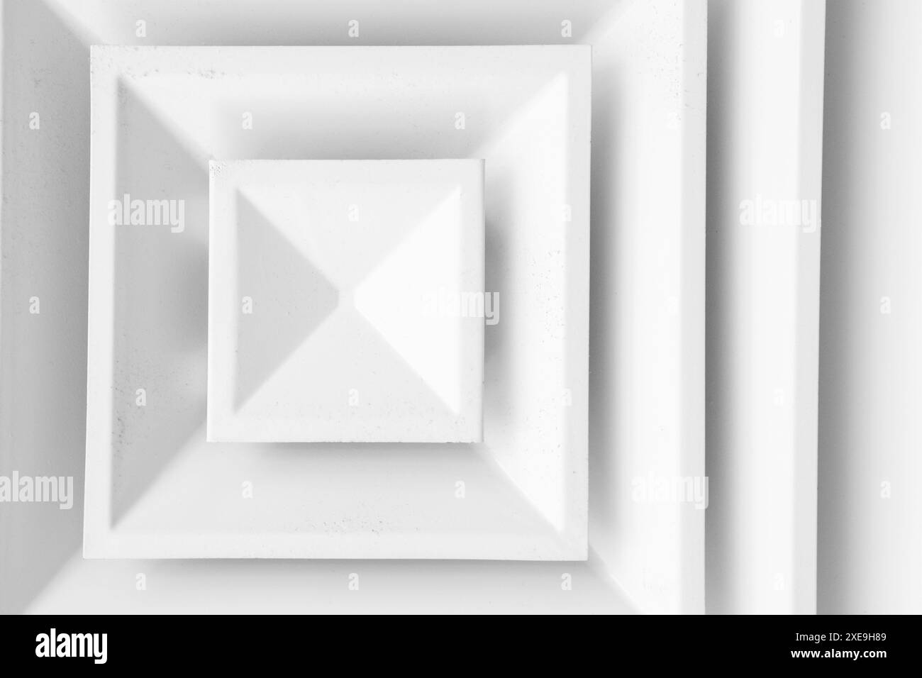 White ceiling ventilation grille with square diffusors, close-up photo ...