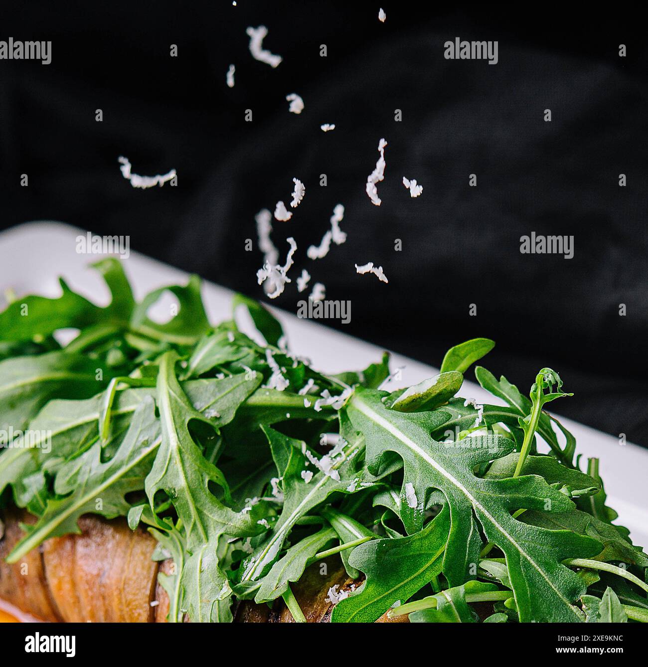 Baked eggplant with arugula and grated parmesan cheese Stock Photo - Alamy