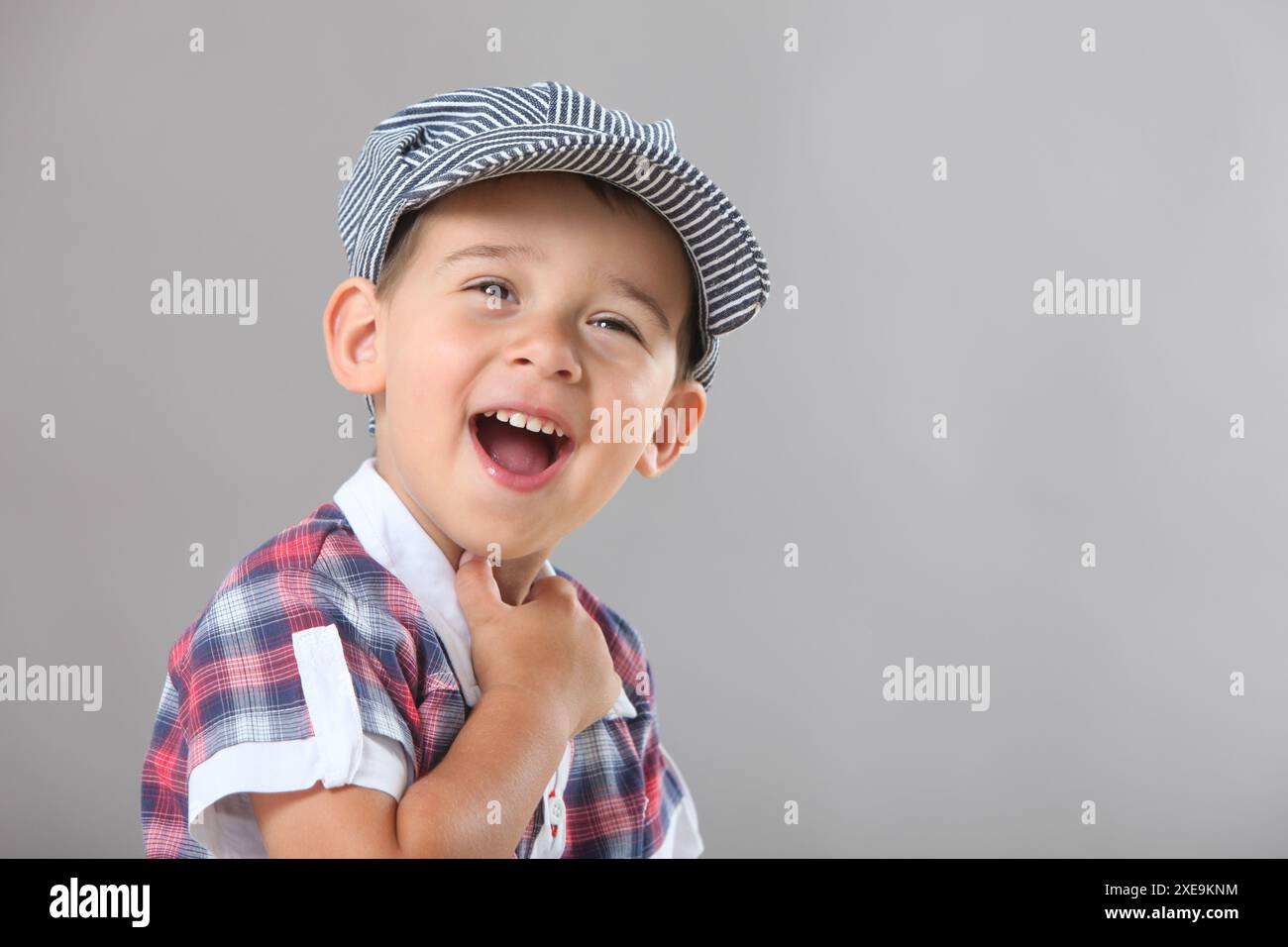 portrait of cheerful little boy on grey background Stock Photo - Alamy