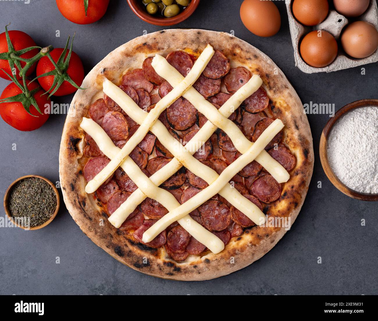 Calabrese sausage and catupiry cheese pizza over stone background with ...