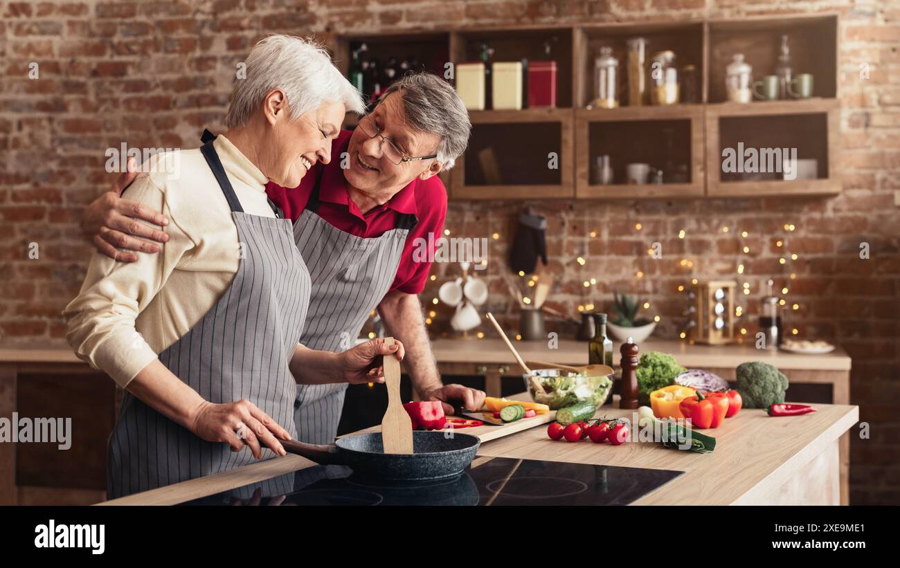 Senior Couple Cooking Together in Modern Kitchen, Embracing Stock Photo ...