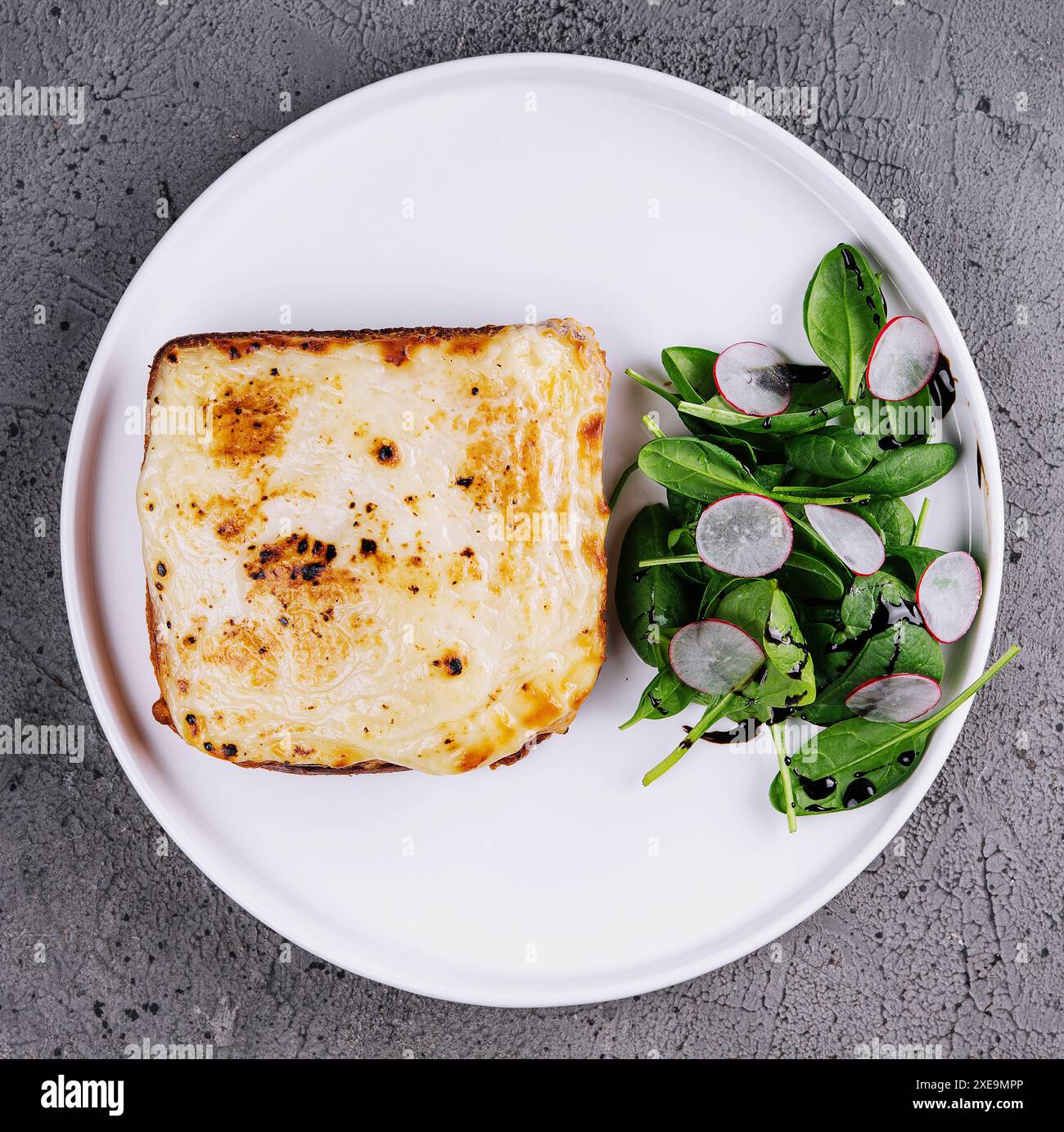 Toast Croc Monsieur with green salad Stock Photo - Alamy