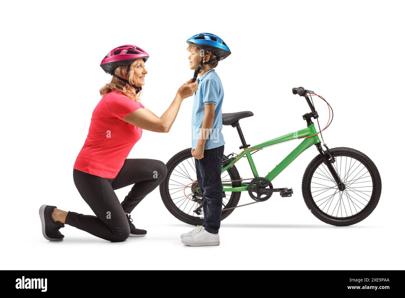 Mother putting on helmet on a boy for a bicycle ride isolated on white ...
