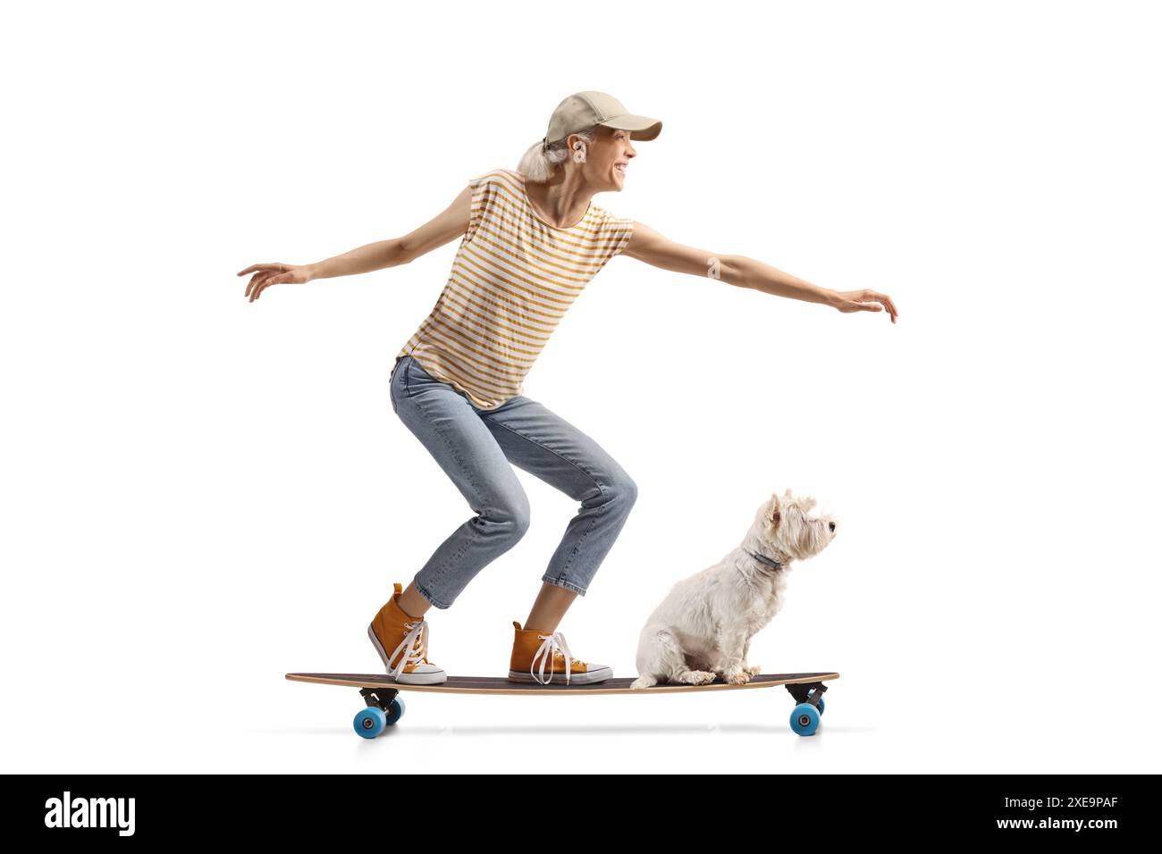 Cheerful young riding a longboard with a dog isolated on white ...