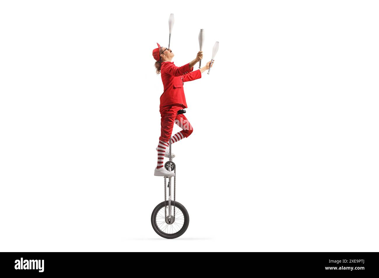 Acrobat riding a giraffe unicycle and juggling isolated on white ...