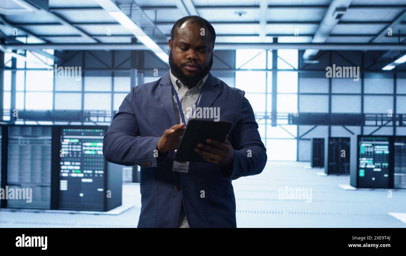 Software developer managing data center with advanced technology, ensuring efficient network ...