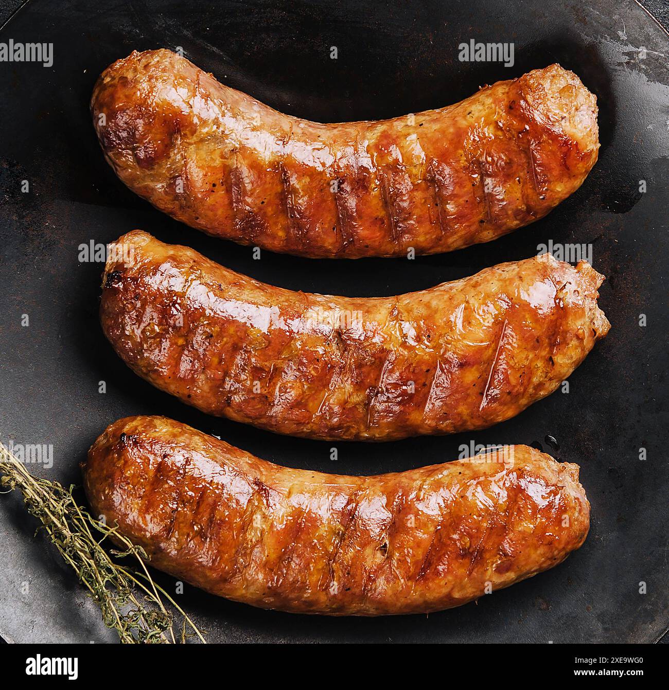 Fried sausages on black pan from above Stock Photo - Alamy